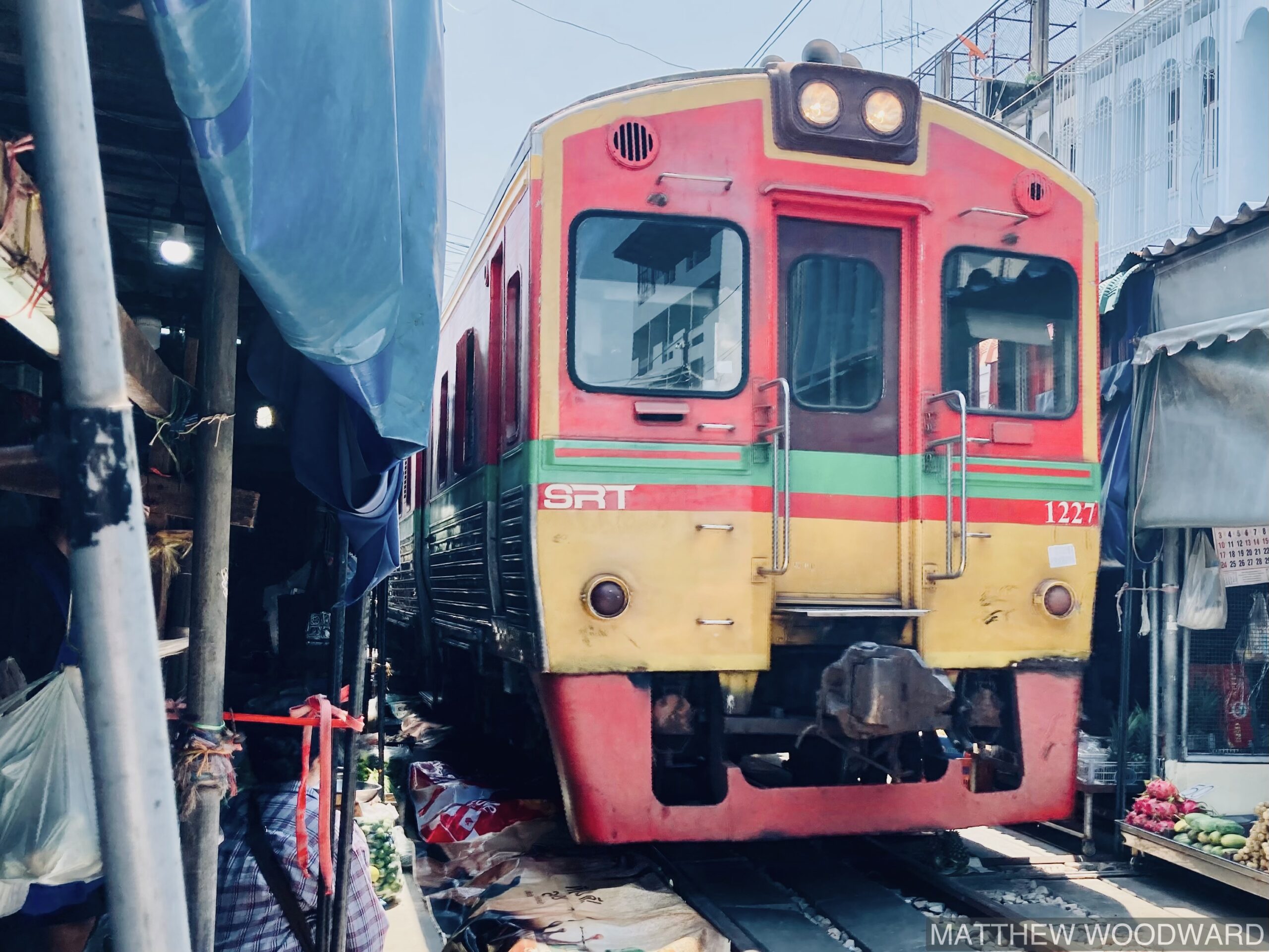 The Maeklong Market Train – Matthew Woodward